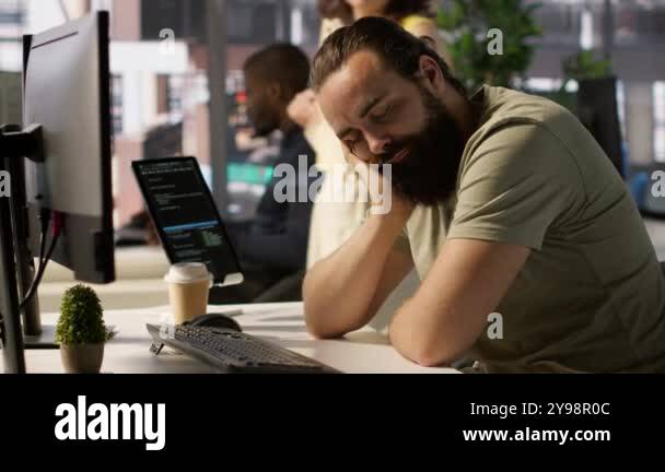 Tired company worker caught falling asleep at desk in office by ...