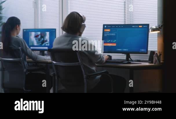 Two diverse workers using AI generator on computers in office. PC screens showing artificial ...