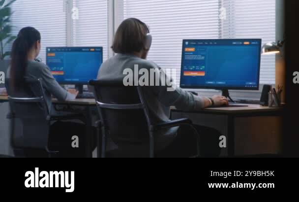 Back view of team of workers using AI generator on computers in office. PC screens showing ...
