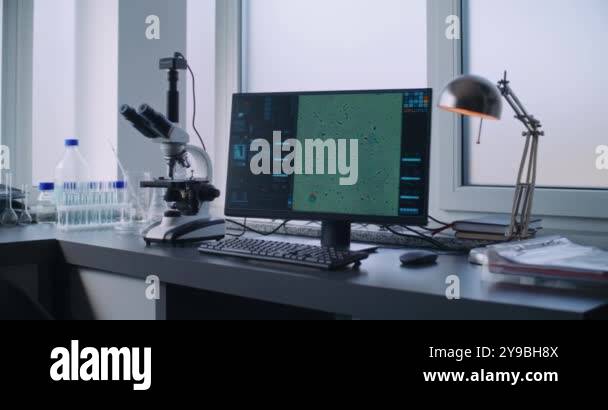 Workplace in advanced medical science laboratory: PC screen shows image ...