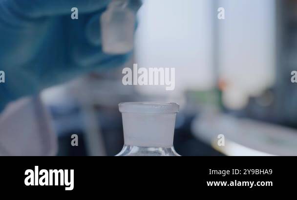 Advanced medical science lab: Close up of chemist pouring liquid from ...