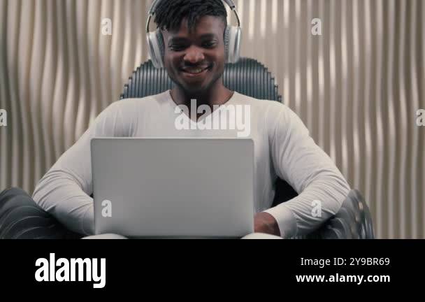 Happy smiling positive satisfied African American man gamer programmer ...