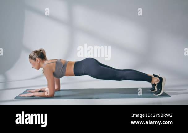 Fitness woman doing plank exercise workout in gym indoors. Attractive ...