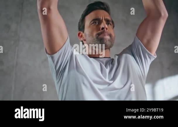 Powerful man lifting weight plate in sport club closeup. Professional ...