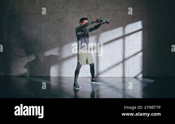Weightlifting man muscle workout in loft gym. Strong guy enjoying ...