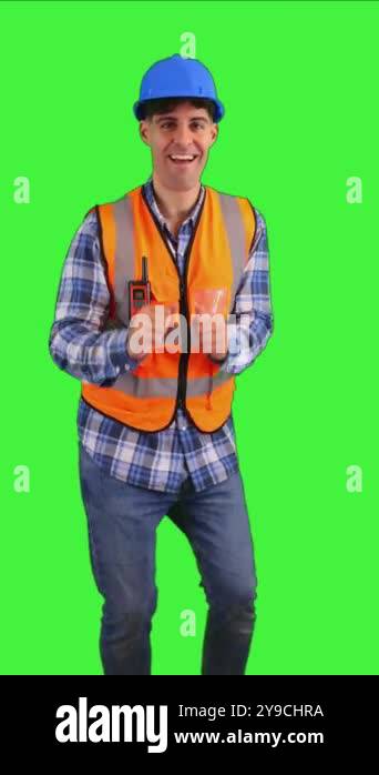 vertical humorous construction worker is joyfully dancing on the job ...