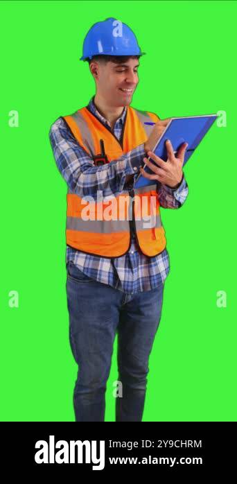 vertical construction worker is diligently taking notes in his notebook ...