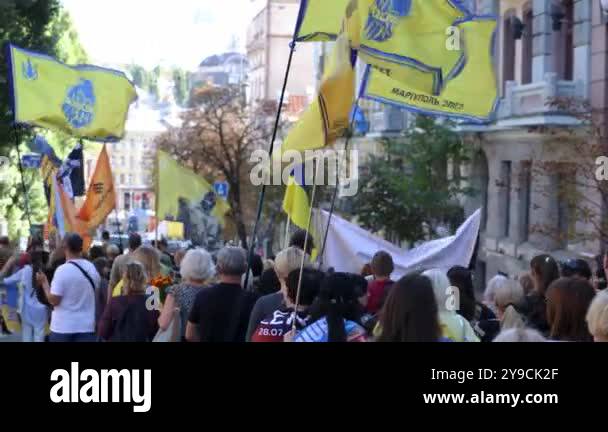 Large group of Ukrainian people walk with flags of Azov brigade and ...
