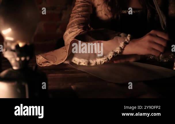 Medieval female writes with old feather pen. Antique young woman in ...
