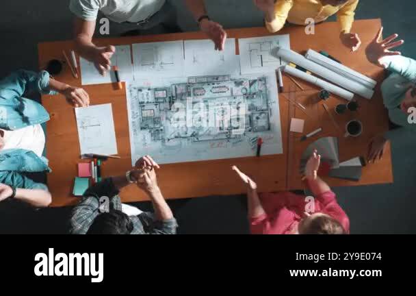 Top down aerial view of designer putting hand together to celebrate ...