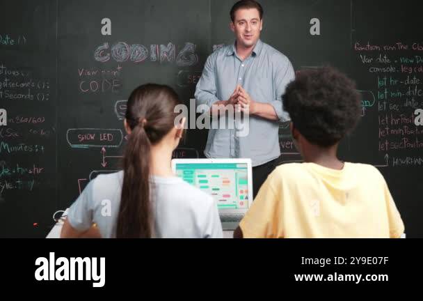 Handsome teacher clapping hands to celebrate successful project while diverse student raised ...