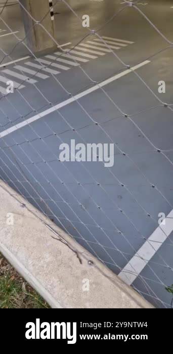 front of the facade with balconies is tensioned cable network covering ...