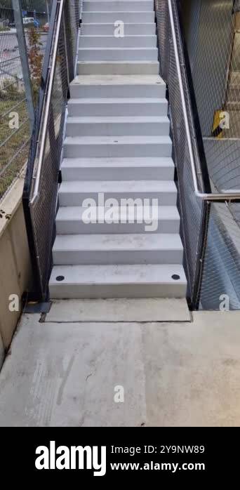 front of the facade with balconies is tensioned cable network covering ...