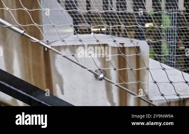 front of the facade with balconies is tensioned cable network covering entire building ...