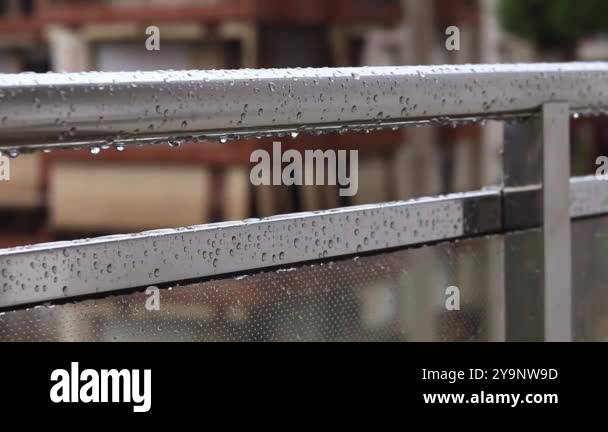Balcony railings in the rain, selective focus. Close-up of balcony ...