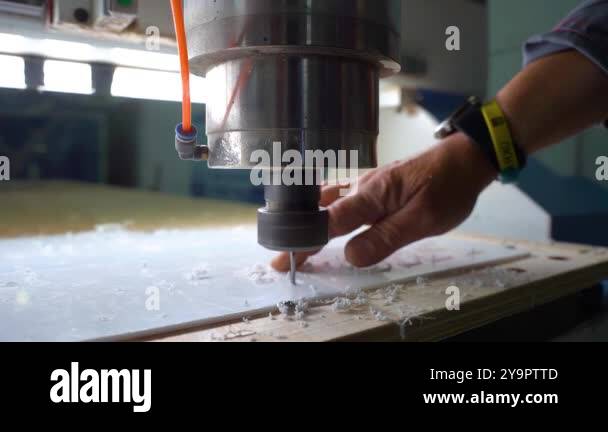 Video set: The milling machine operator cuts letters on plastic ...