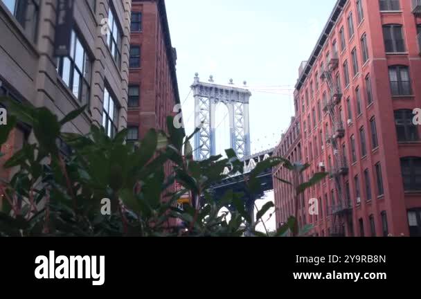 New York City Manhattan Bridge in Dumbo, Brooklyn. Red brick building on Washington street near ...