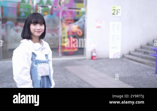 A young Taiwanese woman in her 20s is spending time on stairs in the evening while on a date at ...
