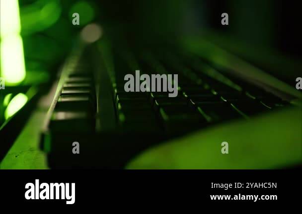 Close up of a man punching the keypad on a computer in a server room ...
