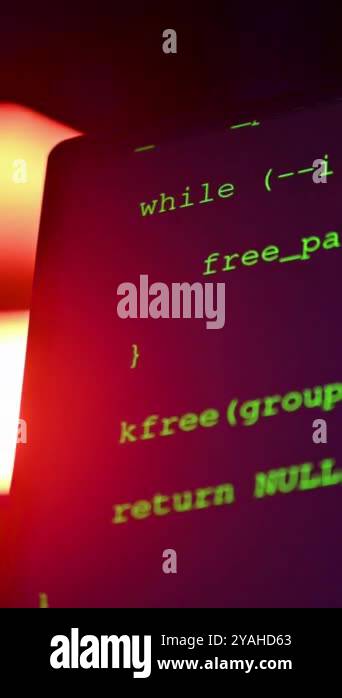 Close up of code on a screen in a server room with flashing colourful ...