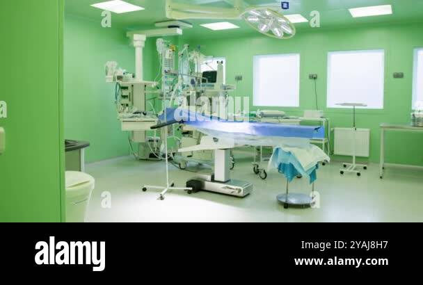Modern operating room featuring green walls and advanced medical ...
