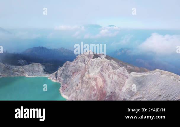 Aerial view of rock cliff at Kawah Ijen volcano with turquoise sulfur ...