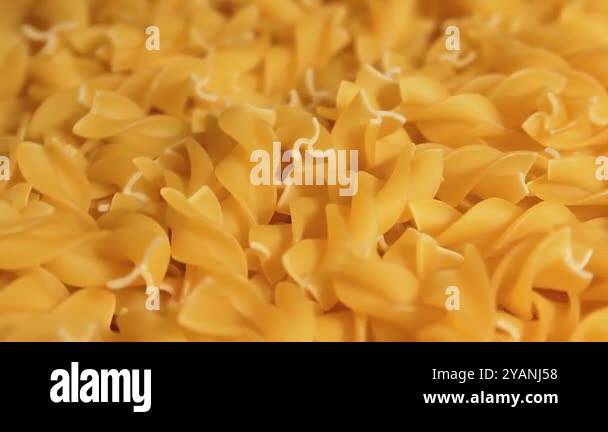 Uncooked Fusilli Pasta Rotating. Fat and Unhealthy Food. Dry Spiral ...