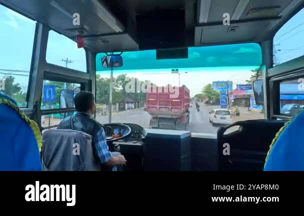 Traveling with a short hop intercity bus in Asia front seat view ...