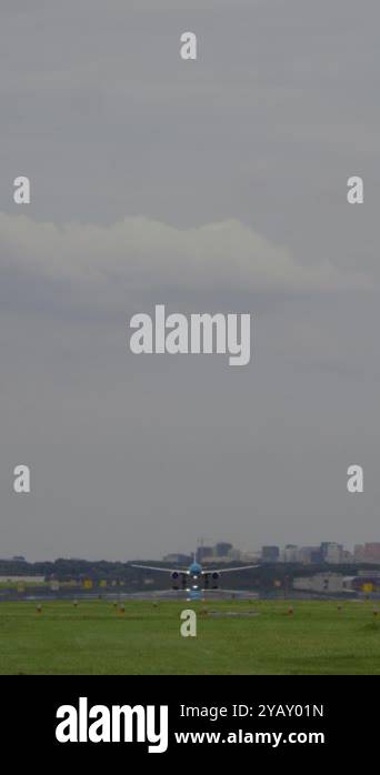 Vertical video of an airplane taking off with the skyline visible in ...