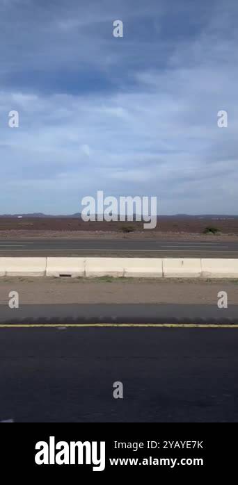 Driving a car on the road. Side view of the desert valley. Saudi ...