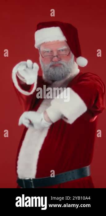 Vertical medium stab shot of eccentric and confident Santa Claus in ...