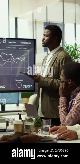 Vertical Video The CEO and management team gathering in boardroom for a project briefing ...