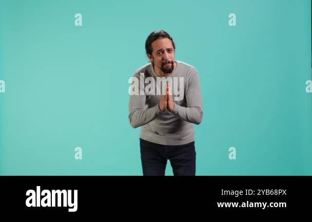 Man putting hands together in apology gesture, asking for forgiveness ...