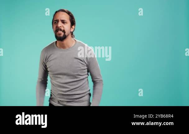 Portrait of irate man feeling outraged, yelling at friend, releasing ...