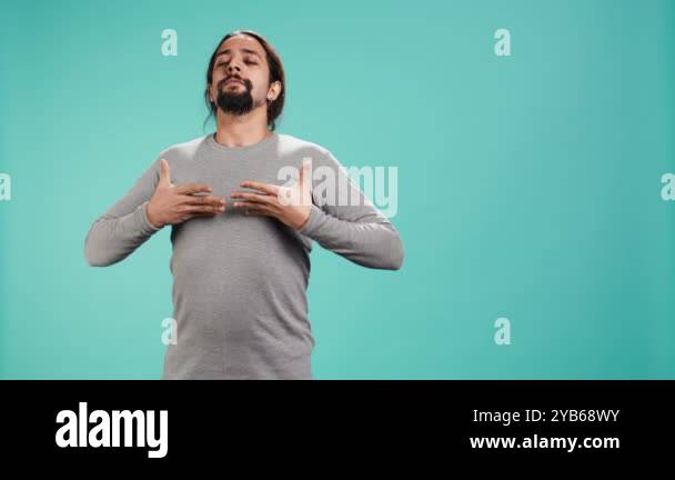 Portrait of man inhaling and exhaling to relax and gain positive energy ...