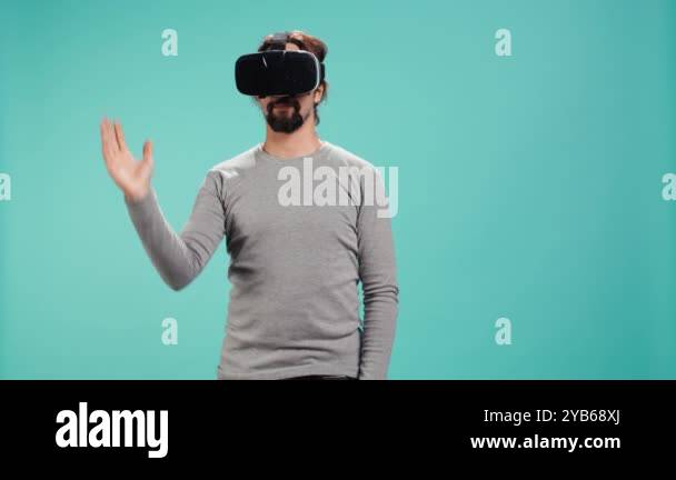 Tech enthusiast wearing virtual reality goggles, doing zooming in ...