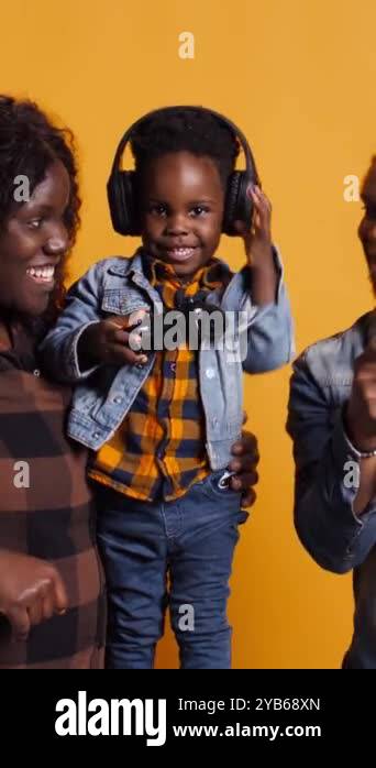 Vertical Video Enthusiastic father playing online video games with baby ...