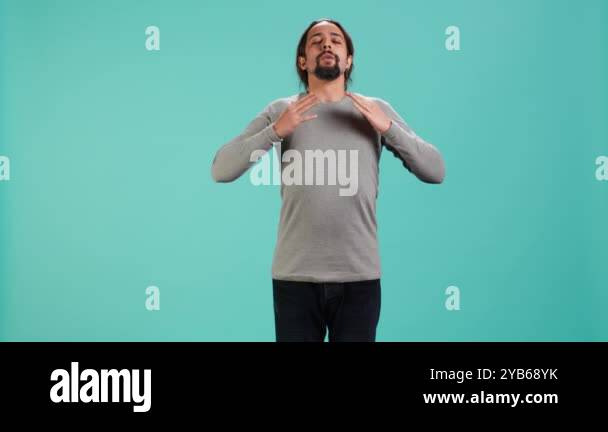 Portrait of man inhaling and exhaling to relax and gain positive energy ...