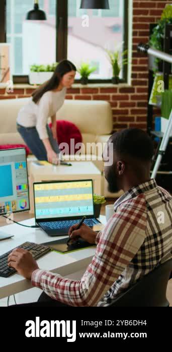 Vertical Video Freelance graphic designer editing photos on a modern ...