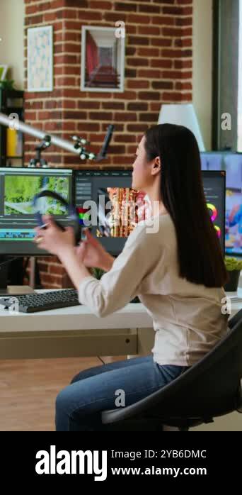 Vertical Video Asian filmmaker woman putting headphones on and working ...