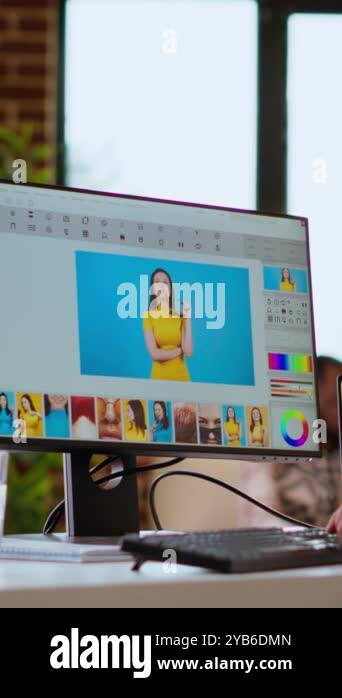 Vertical Video Freelance designer works on a photo editing project in a ...
