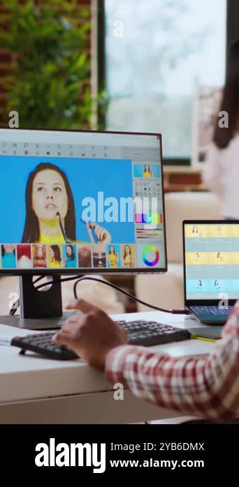 Vertical Video Freelance graphic designer editing photos on a modern ...