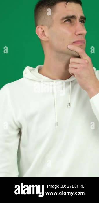 emotions of a handsome man guy on a green background chromakey close-up ...