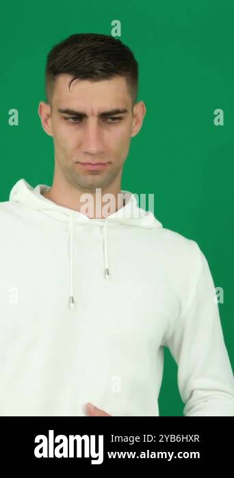 emotions of a handsome man guy on a green background chromakey close-up ...