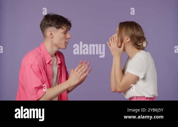 Young man and woman posing in studio. Positive couple of young ...