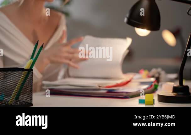 Female employee works with report papers. Workaholic woman at office ...