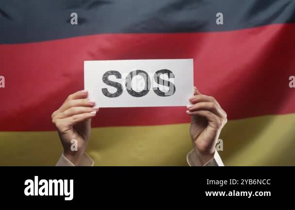 Female hands with SOS, alarm, emergency card on Deutschland flag ...