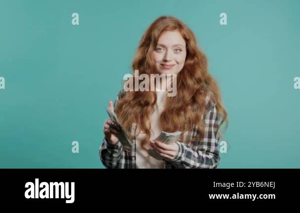 Rich excited ginger haired woman with cash money - USD currency dollars ...