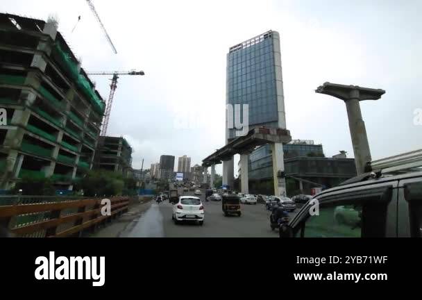 Mumbai, India, 22 June 2024. Vehicles zooming past the construction ...