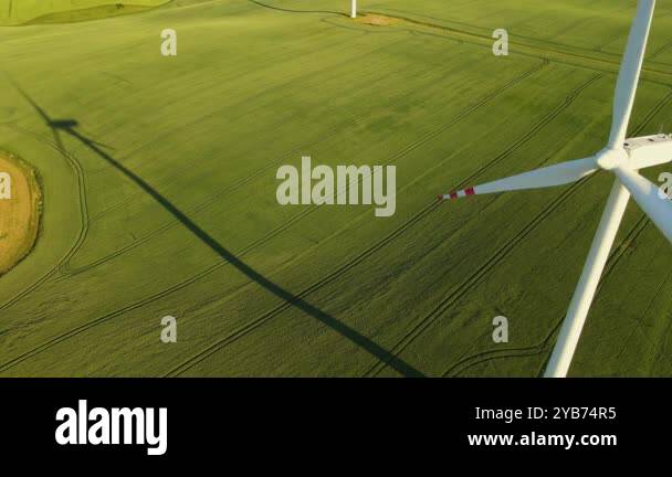 Electricity production by wind generator on wind farm. Windmill blades ...
